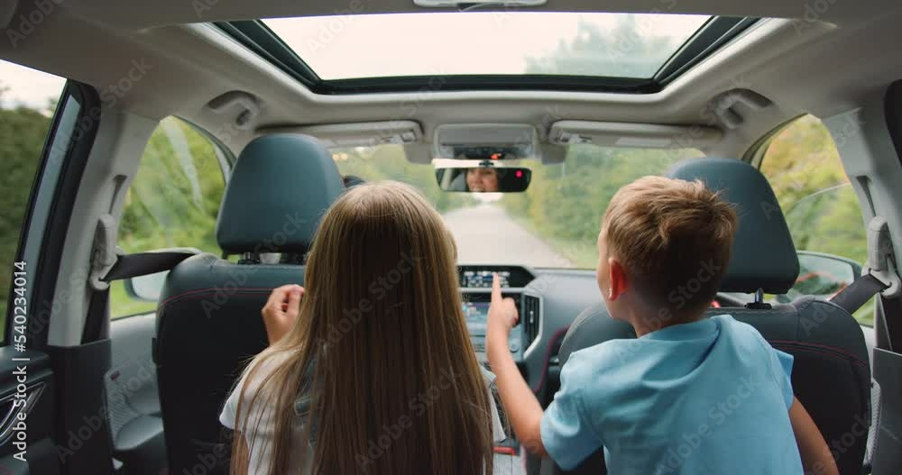 Back view when attractive positive two teen kids watching at the road ...