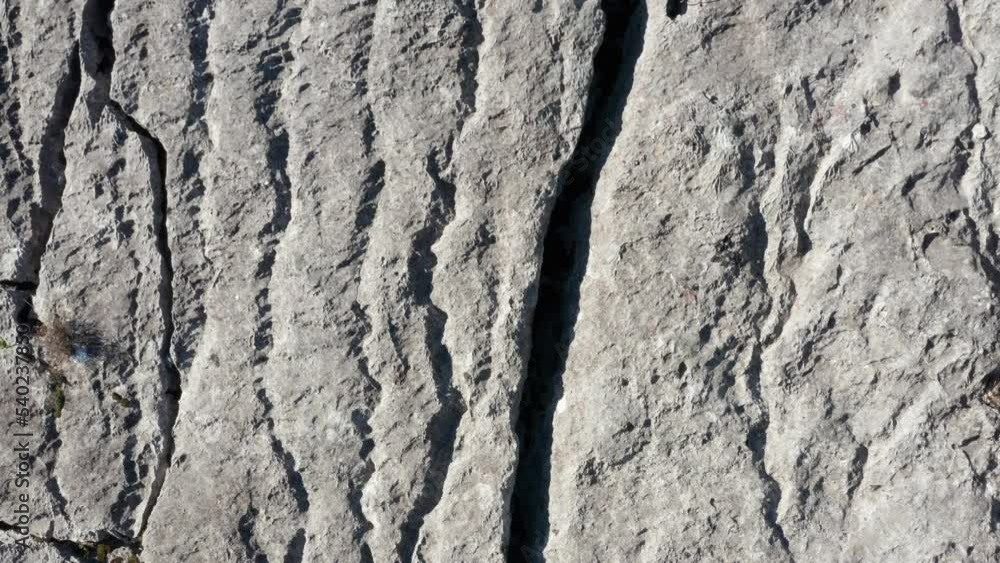 Erosion of bare wrinkled rock - texture of rough stone with grooves and ...