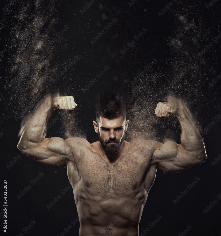 Muscly shirtless bodybuilder flexing his biceps, disintegrating into ...
