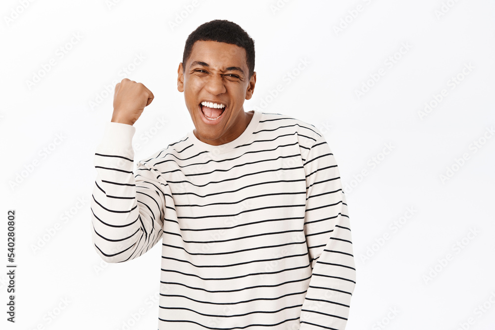 Enthusiastic african american man, cheering, chanting for someone ...