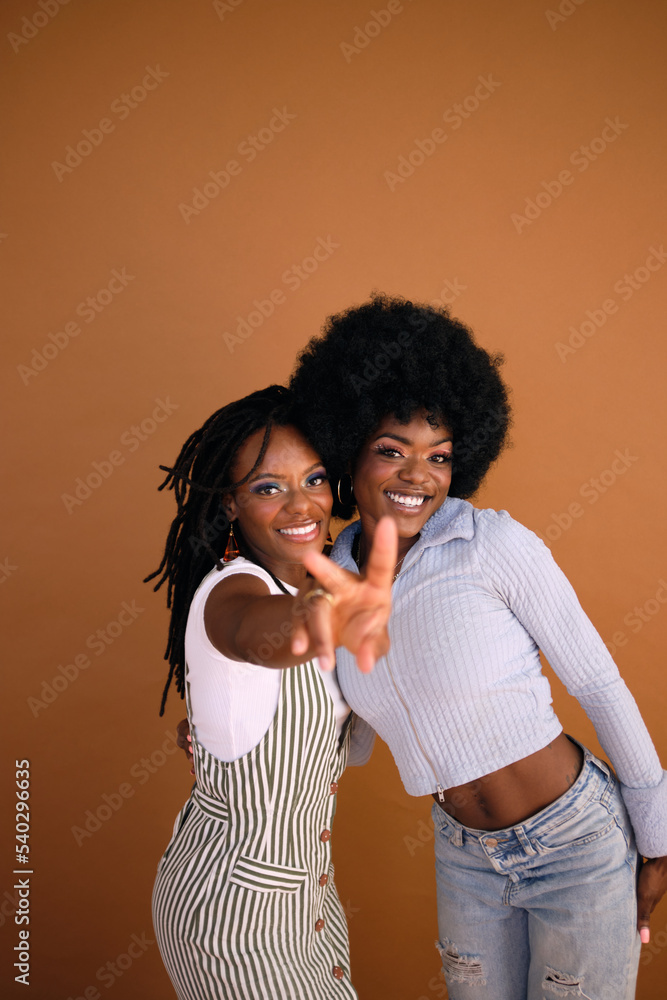 Studio portrait of two young beautiful women smiling Stock Photo ...