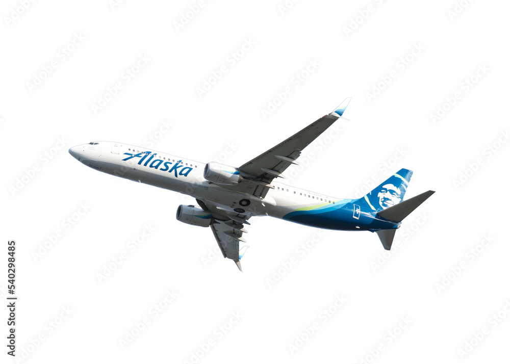 Flying airplane from Alaska Airlines isolated on white background. A ...