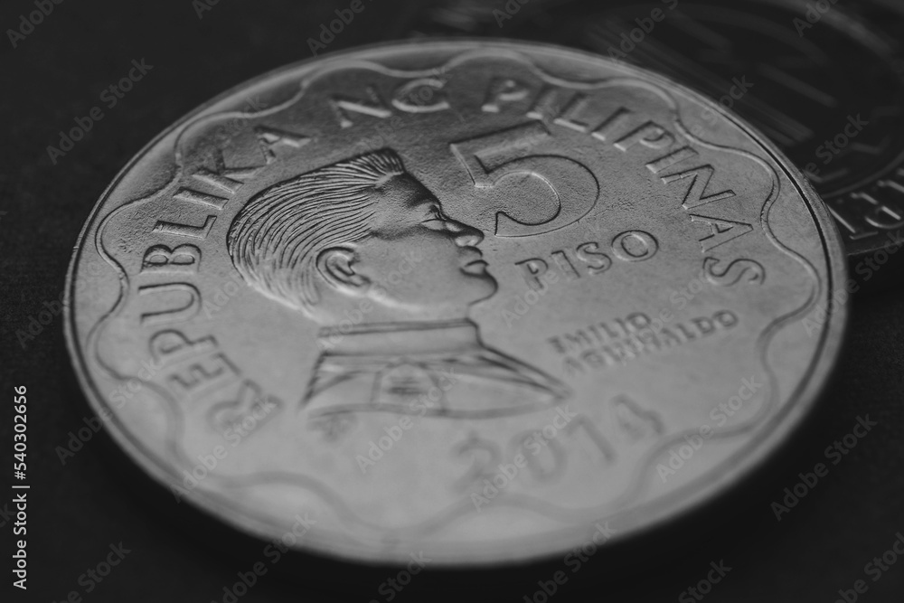 Philippine money lie on dark surface. Coin of 5 pesos close-up. Peso of ...