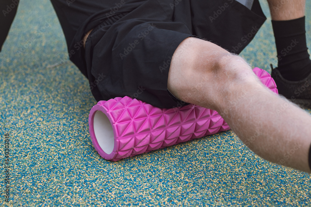 Fitness trainer exercises and warms up the lower part of the body with ...