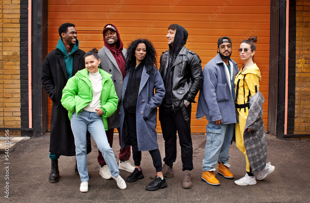 Multiracial group of young friends together on city street against ...