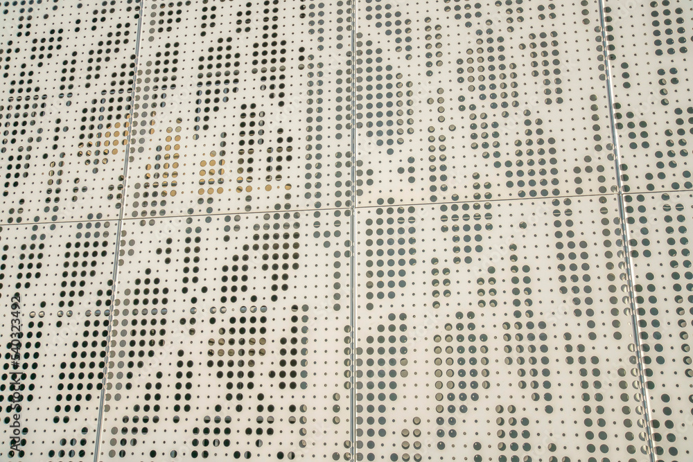 Beige sheet metal wall with holes in a close-up view Stock Photo ...
