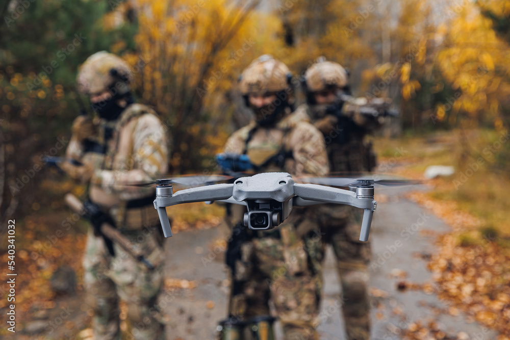 Modern army soldiers using aerial drone for artillery guidance and ...