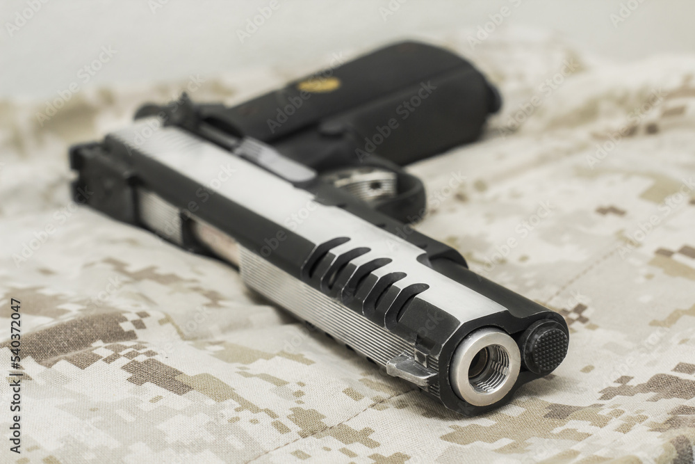 M1911 precising pistol weapon lay on digital Marine Desert camouflage ...