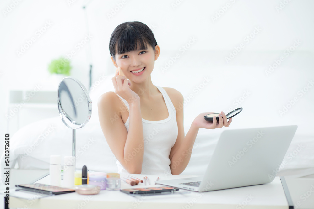Beauty of young asian woman with learning makeup with powder puff on ...