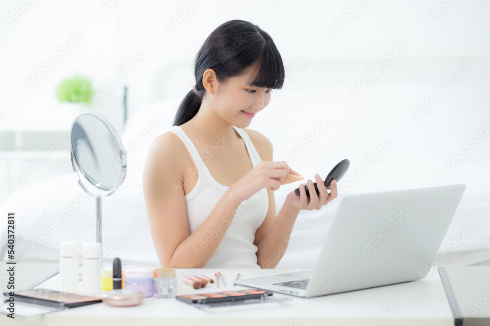 Beauty of young asian woman with learning makeup with powder puff on ...