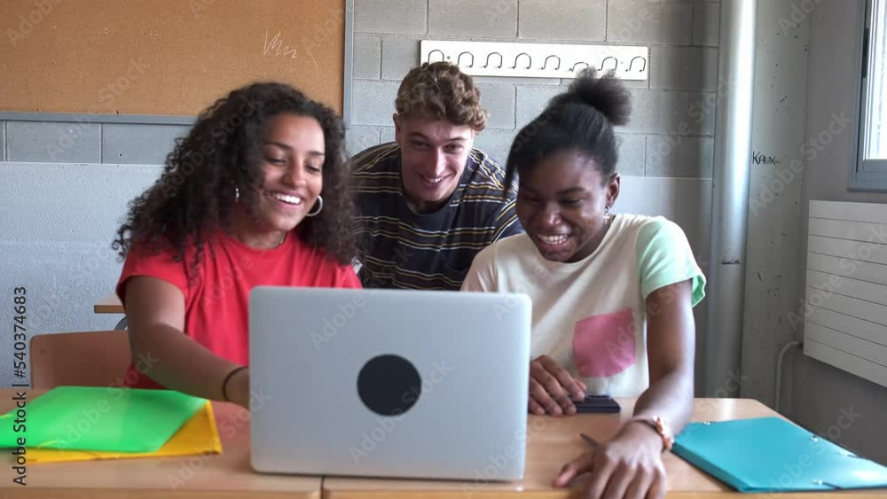 Multiracial group of high school students doing homework research ...
