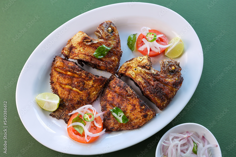 Kerala fish fry Karimeen Pollichathu a popular hot and spicy baked fish in banana leaves ...