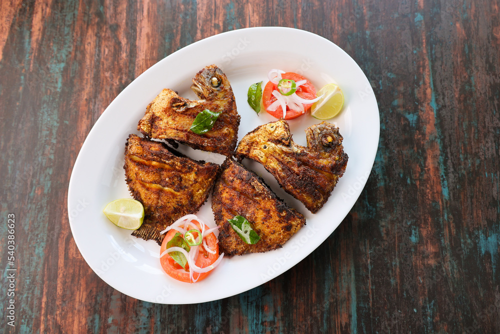 Kerala fish fry Karimeen Pollichathu a popular hot and spicy baked fish ...