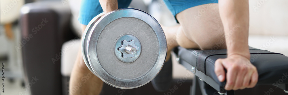Man lifting heavy dumbbell with one hand, train body and muscles ...