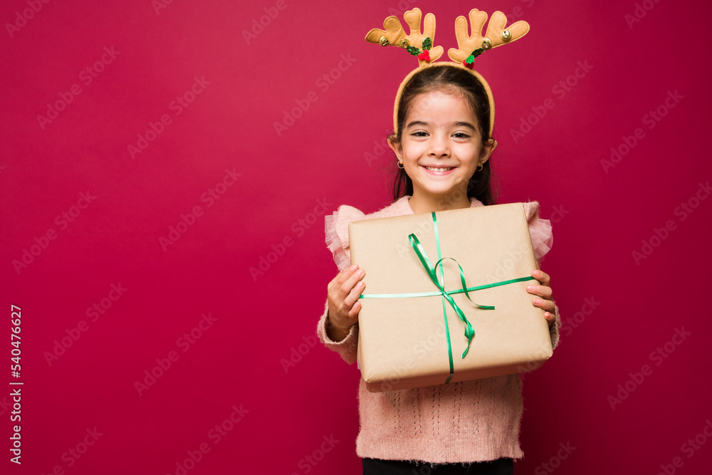 Cheerful kid feeling happy with her christmas gift Stock Photo | Adobe ...
