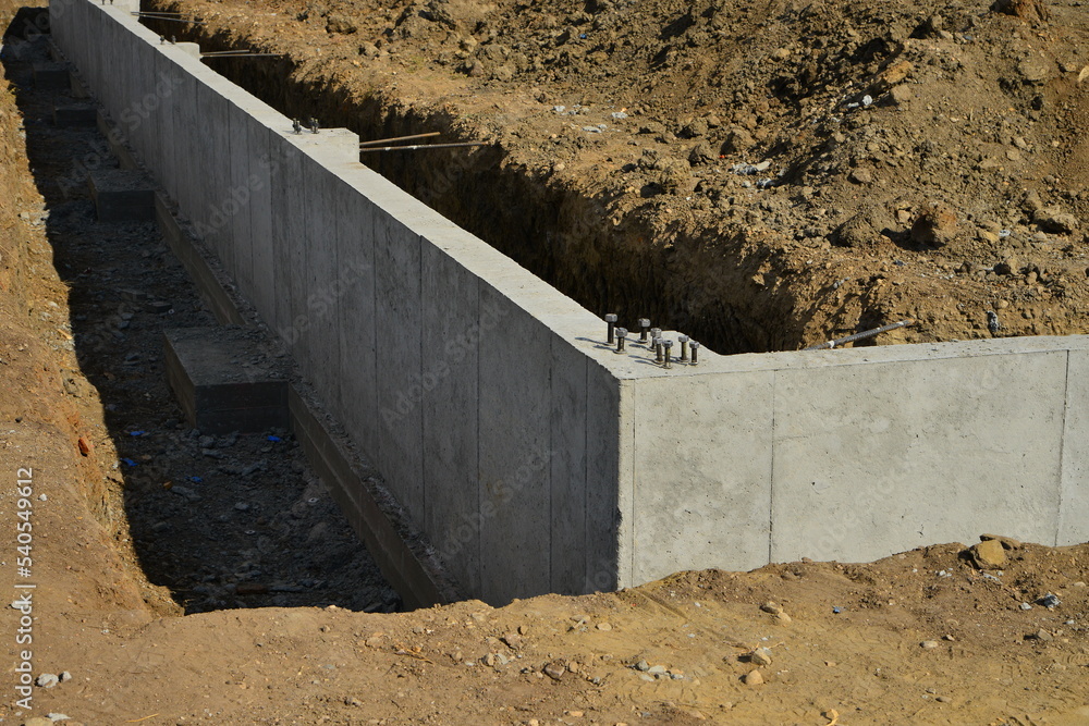 Concrete footings and foundation with anchor bolts ready for more ...