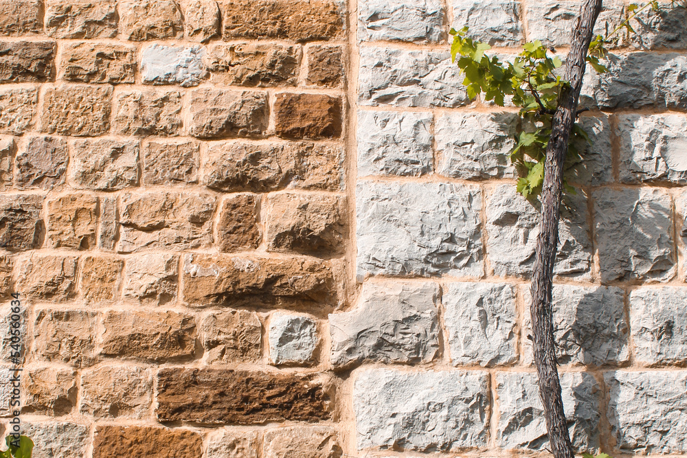Lebanese traditional house, the wall showing two types of stones, brown ...
