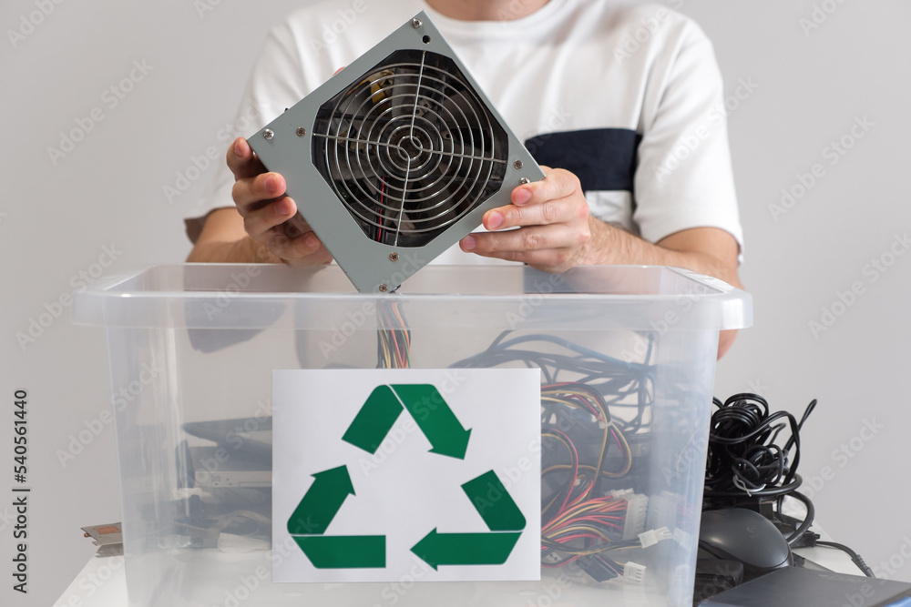 Man sorting broken computer parts in recycle container. Waste ...