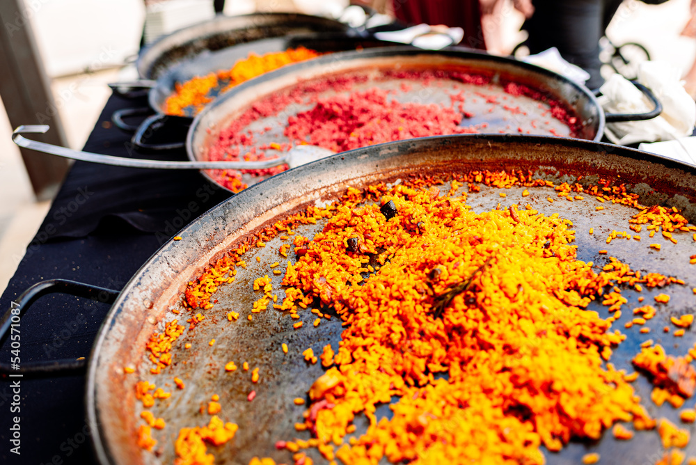 Variety of types of Valencian paellas with rice of different colors and ...