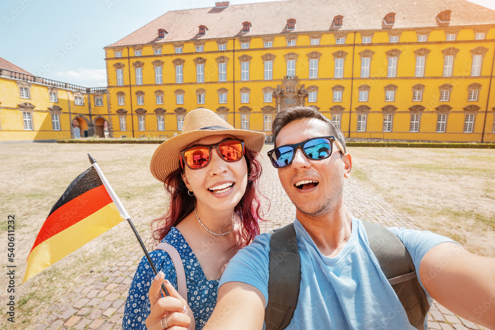 Two happy Travel bloggers takes selfie photos with german flag on the ...