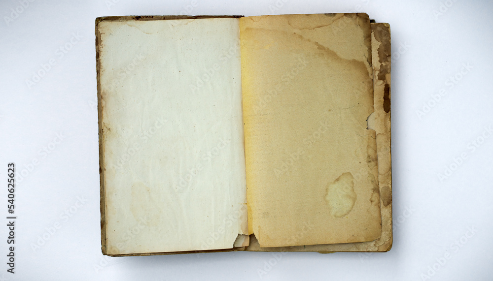 An open old book with clean yellowed pages on a white isolate. Vintage ...