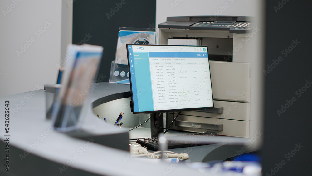 Empty hospital reception desk with computer and medical forms to make ...
