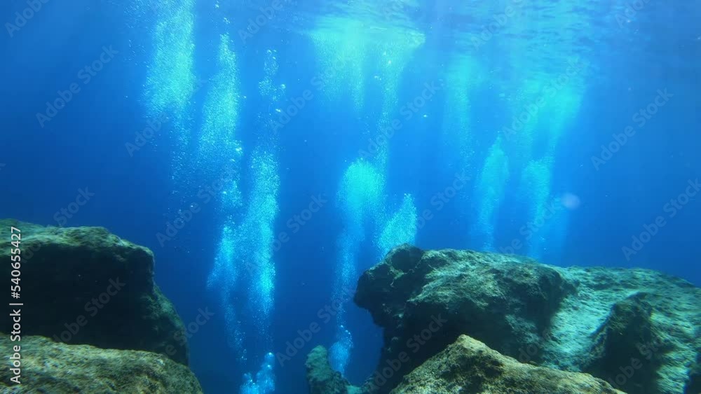 Air bubbles rising from the bottom of the ocean. Pure sea water. Divers ...