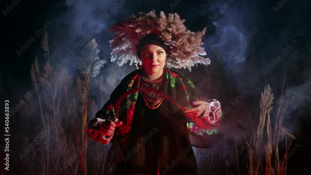 Ukrainian witch - woman in traditional costume with sickle in reeds at ...