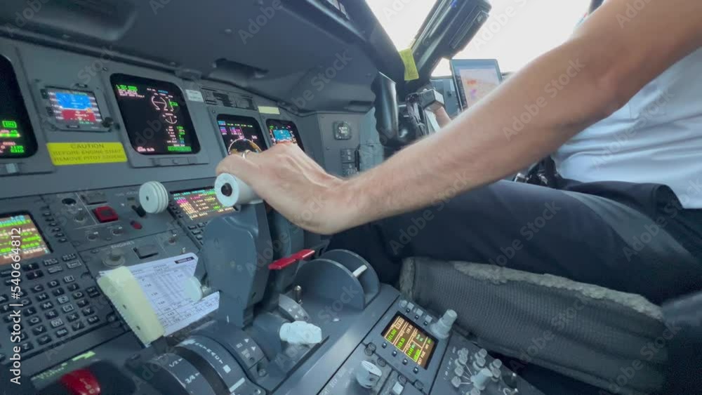 Close view of jet flight controls and engine throttles while copilot is ...