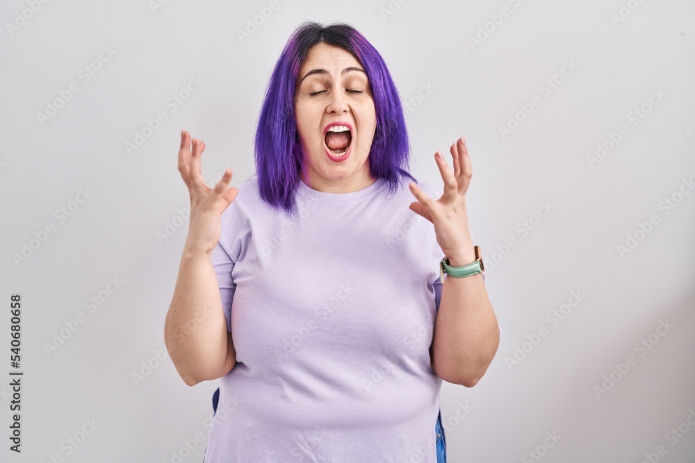 Plus size woman wit purple hair standing over isolated background crazy ...