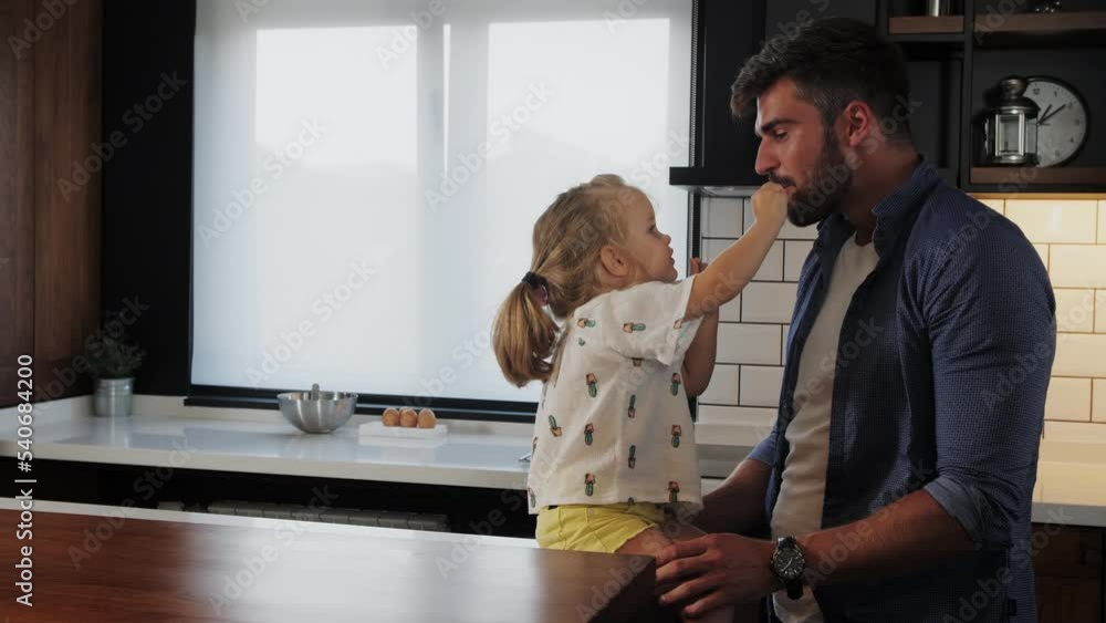 Cute girl sharing cookie with dad and clapping Stock Video | Adobe Stock