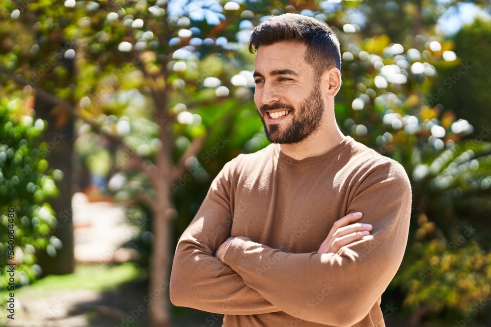 Young hispanic man smiling confident standing with arms crossed gesture ...