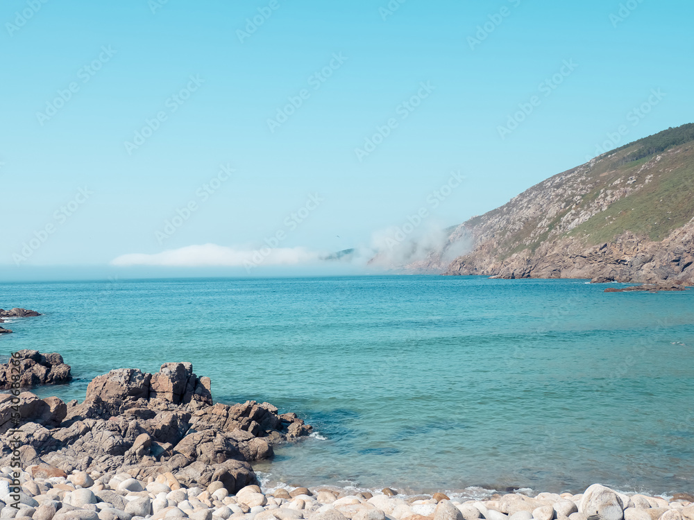 Summer day with fog in Moreira beach in Muxia, Costa da Morte, Galicia ...
