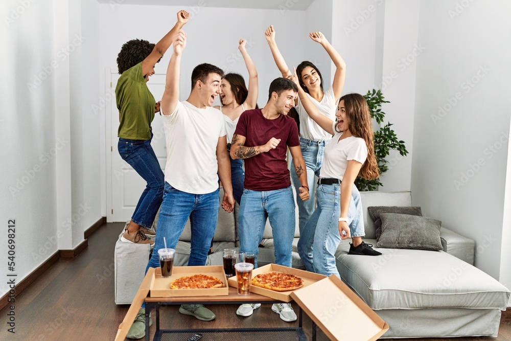 Group of young friends having party eating italian pizza and and ...