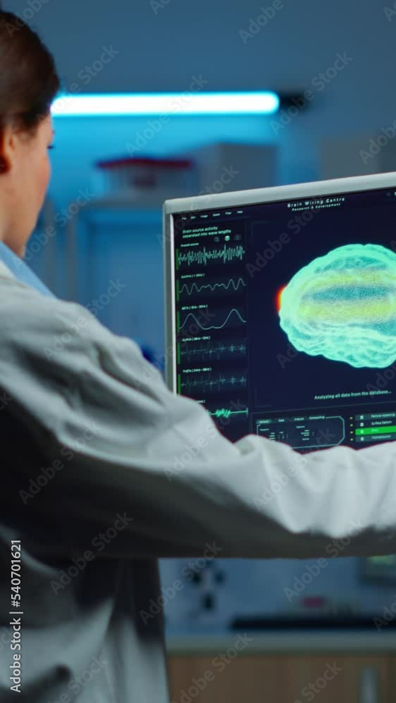 Vertical video: Neurologist doctor reading informations of patient ...