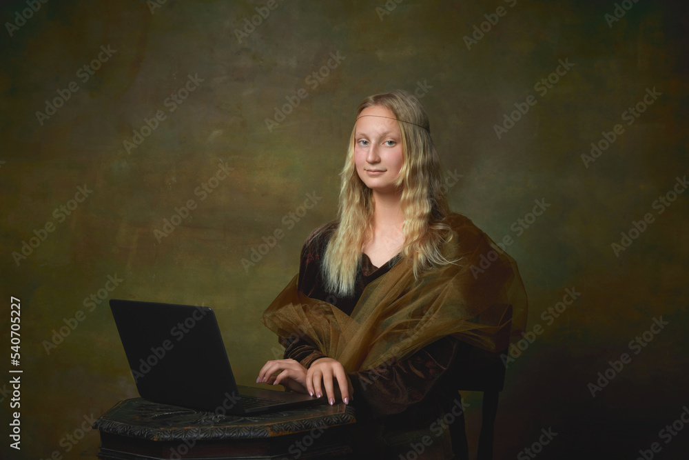 Young charming girl in image of Mona Lisa, La Gioconda using laptop ...