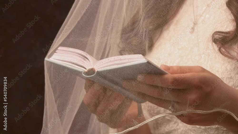 Jewish woman reading scripture under her vail Stock Video | Adobe Stock