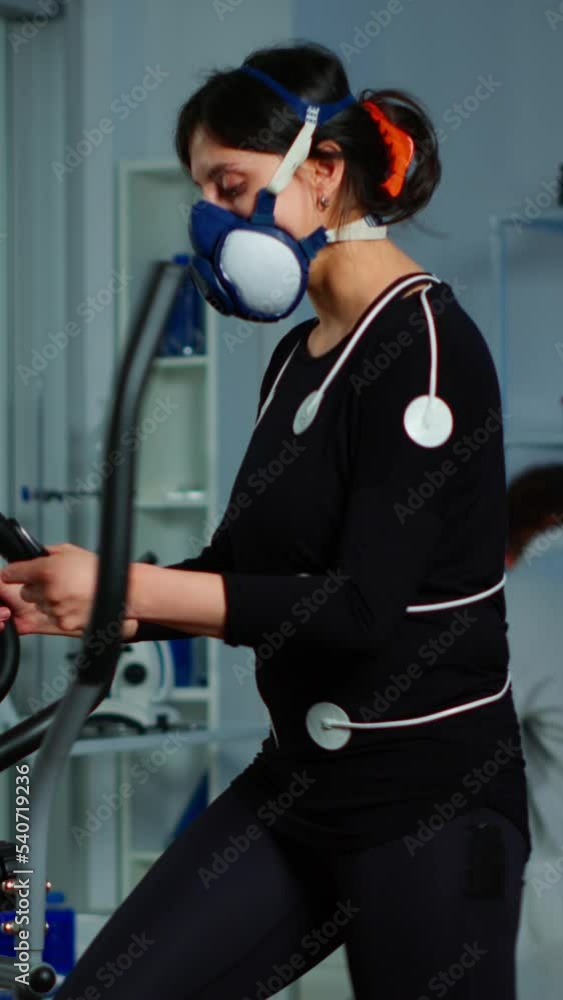 Vertical video: Team of doctor researchers monitoring endurance of ...