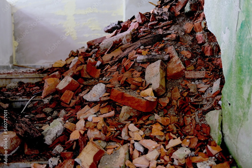 ruined room in abandoned building, pile of bricks lying around, green ...