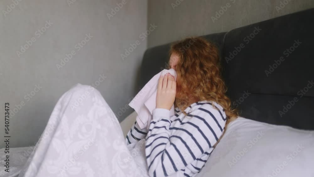 Wideo Stock: Woman sick with flu coughing and blowing her nose on her ...
