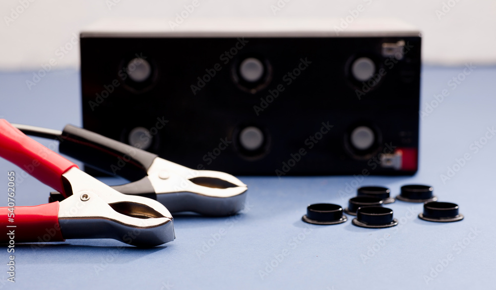 battery maintenance concept, red and black connection pins with battery ...