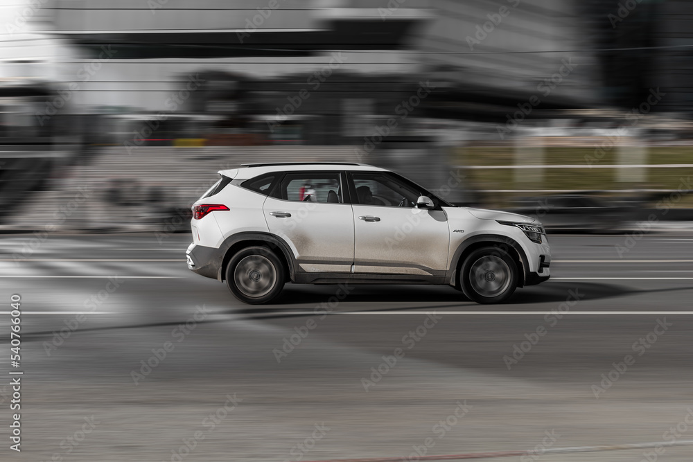 kia seltos car moving on the street. Compact SUV vehicle driving along ...