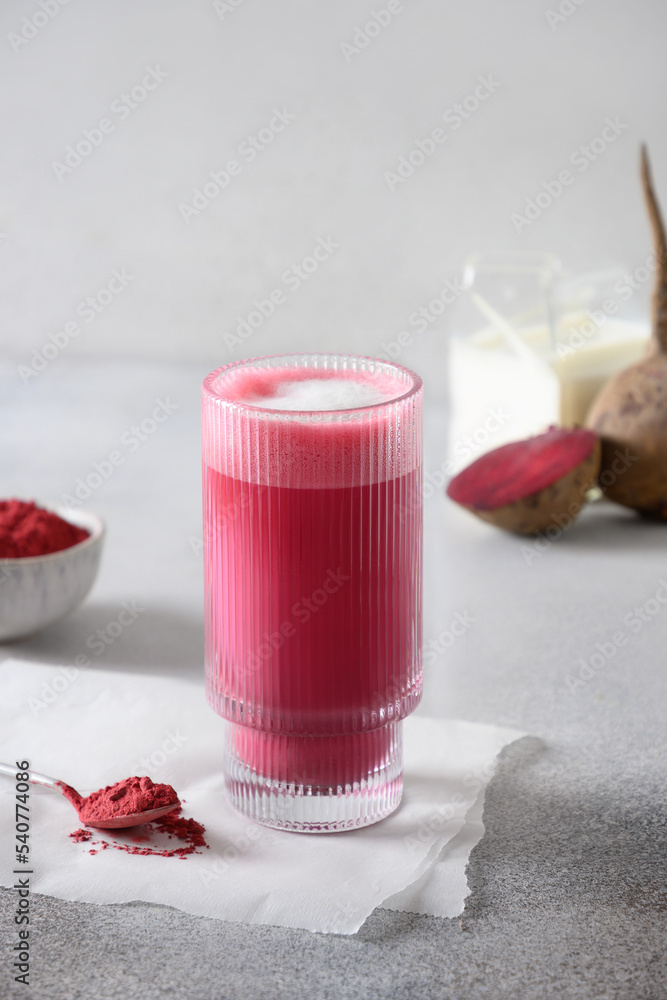 Beetroot latte or pink moon milk latte of beetroot powder in glass on ...