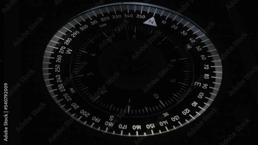 Vessel's compass. Needle almost to north. Scale with numbers spinning ...