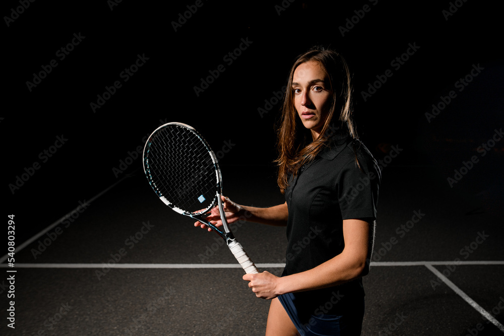 portrait of handsome woman tennis player with brown hair in black ...