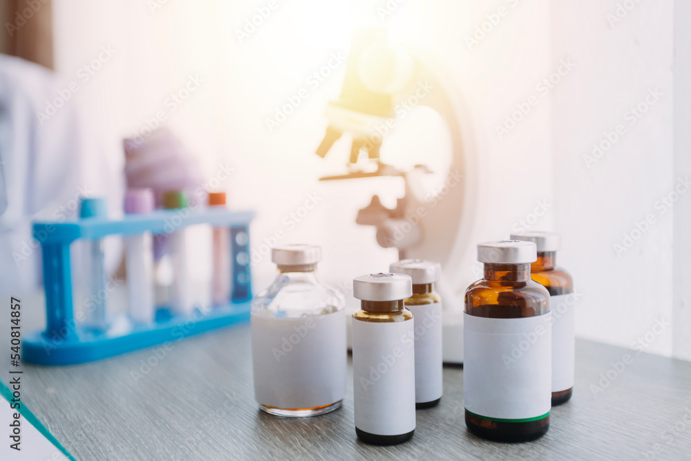 biochemical research scientist team working with microscope for ...