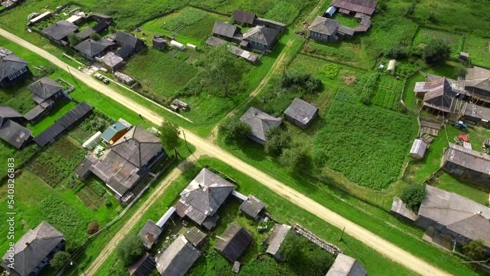 Top view of rustic cottages with green fields. Stock footage. Neat ...