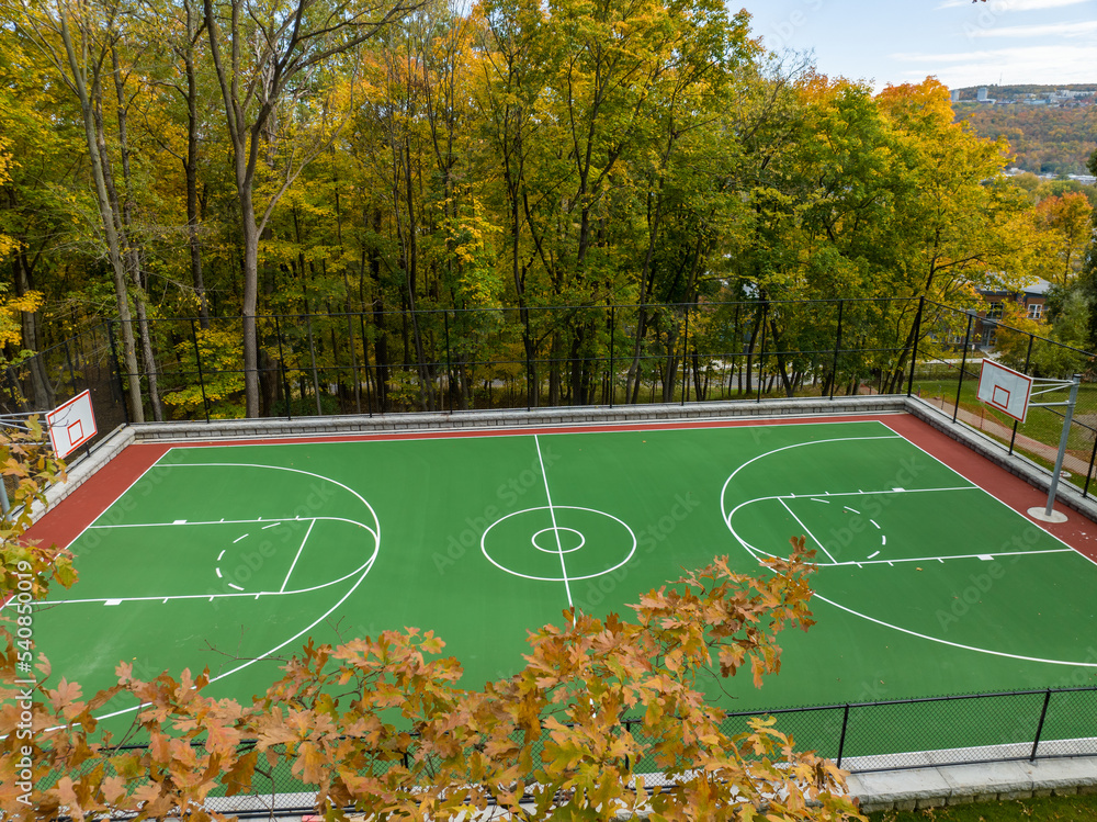 Aerial photo of a green and red outdoor basketball court at school ...