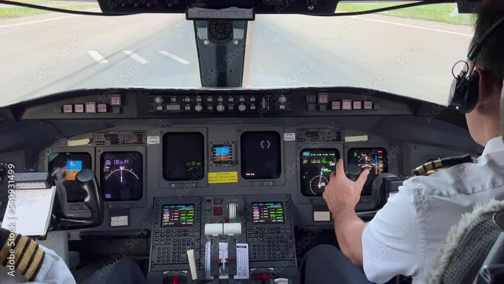 Exclusive view of a jet cockpit during take-off phase. Copilot flying ...