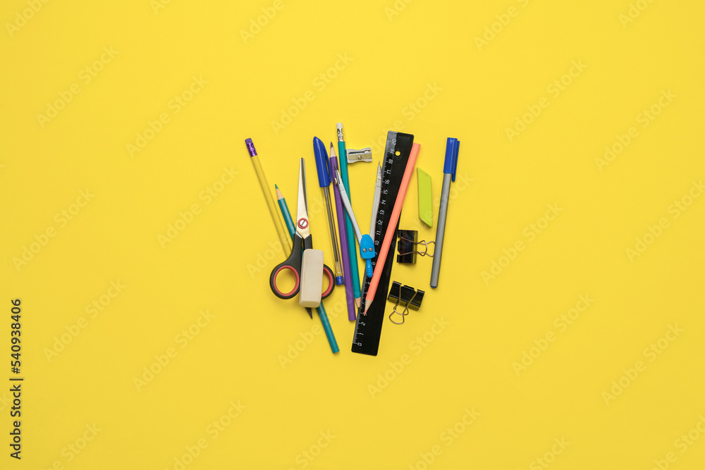 top view layout of some different school supplies on pastel background ...